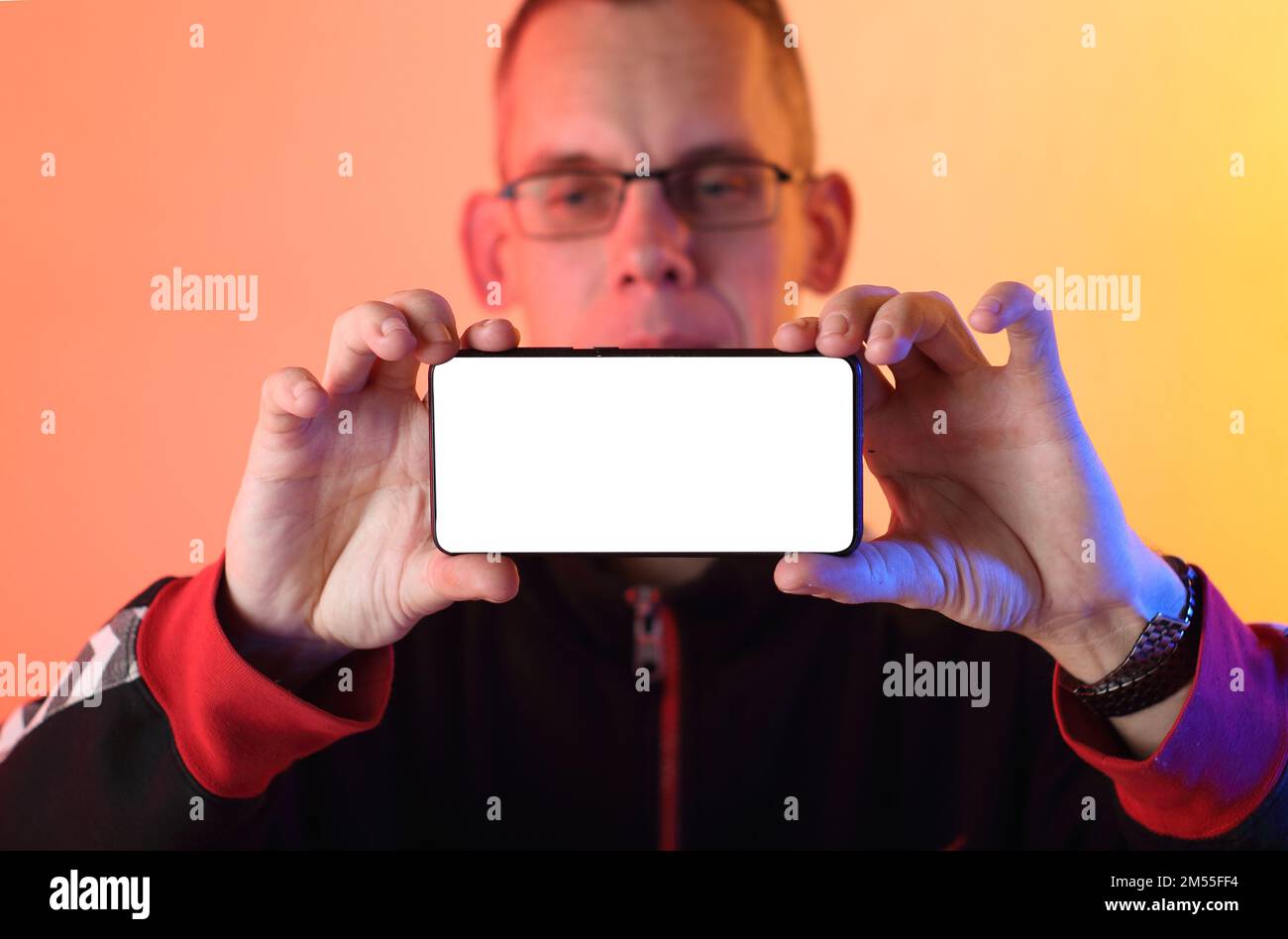 smartphone with a white screen horizontally in the hands against the ...