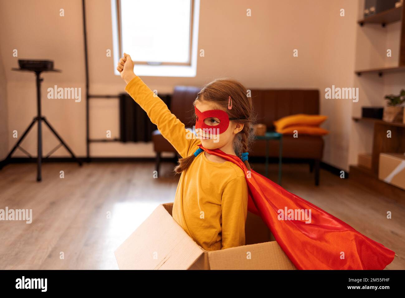 Superhero child. Super hero kid, playing at home in box. Moving ...