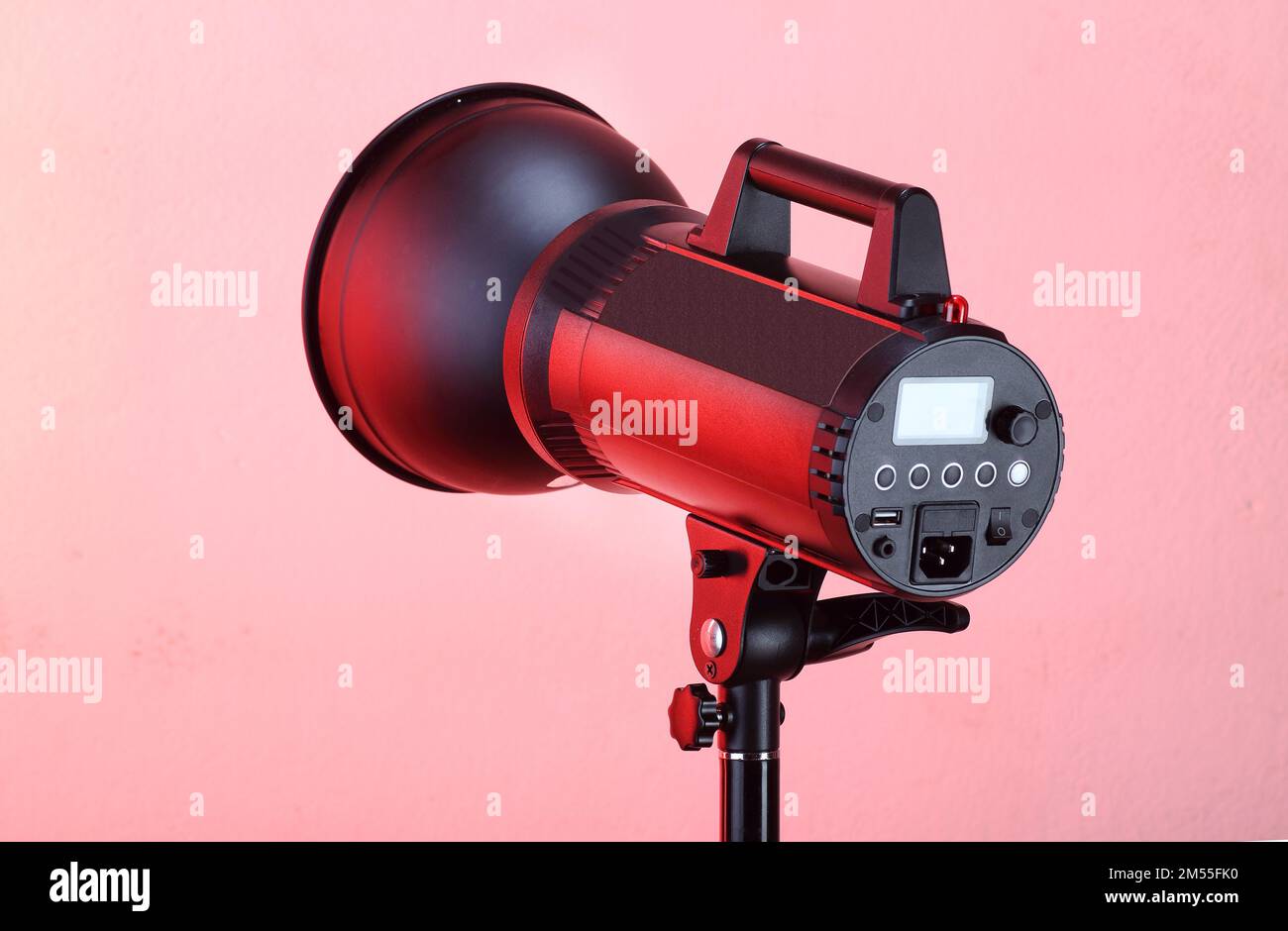 studio flash on a tripod of different colors against a pink wall Stock ...
