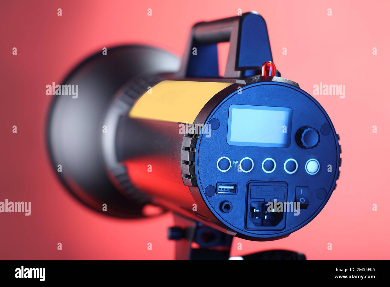 studio flash on a tripod of different colors against a pink wall Stock ...