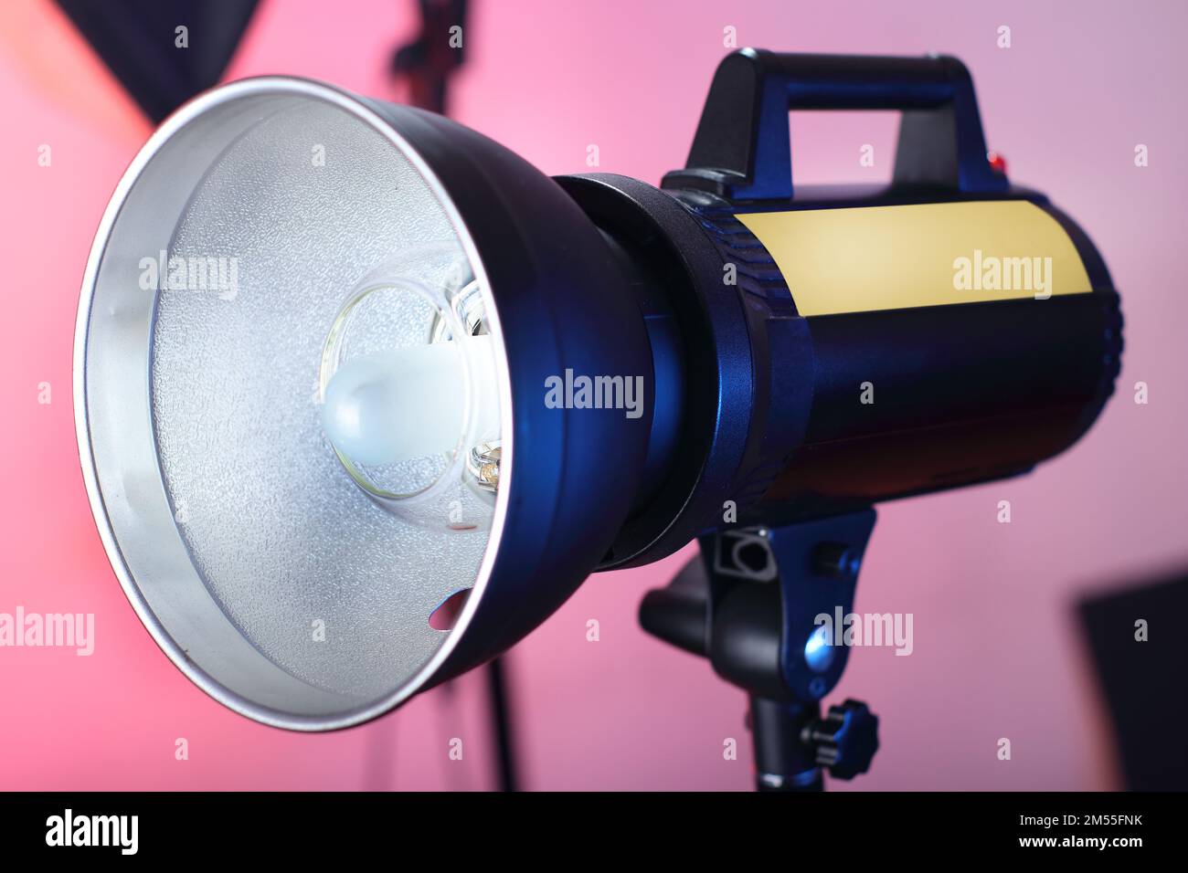 studio flash on a tripod and pink background Stock Photo - Alamy