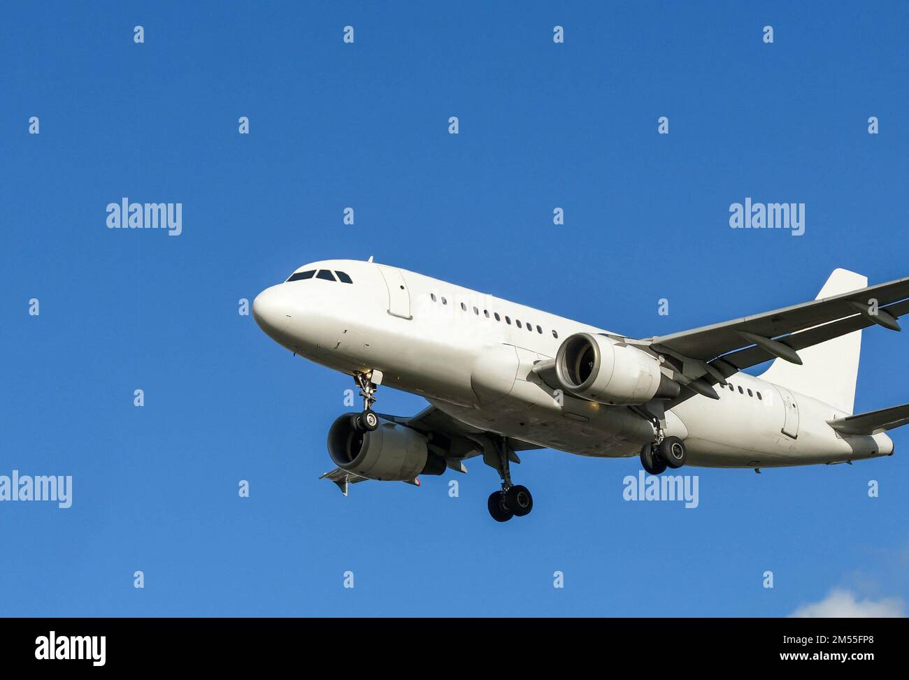 Unmarked passenger jet about to land at a holiday airport. No people ...
