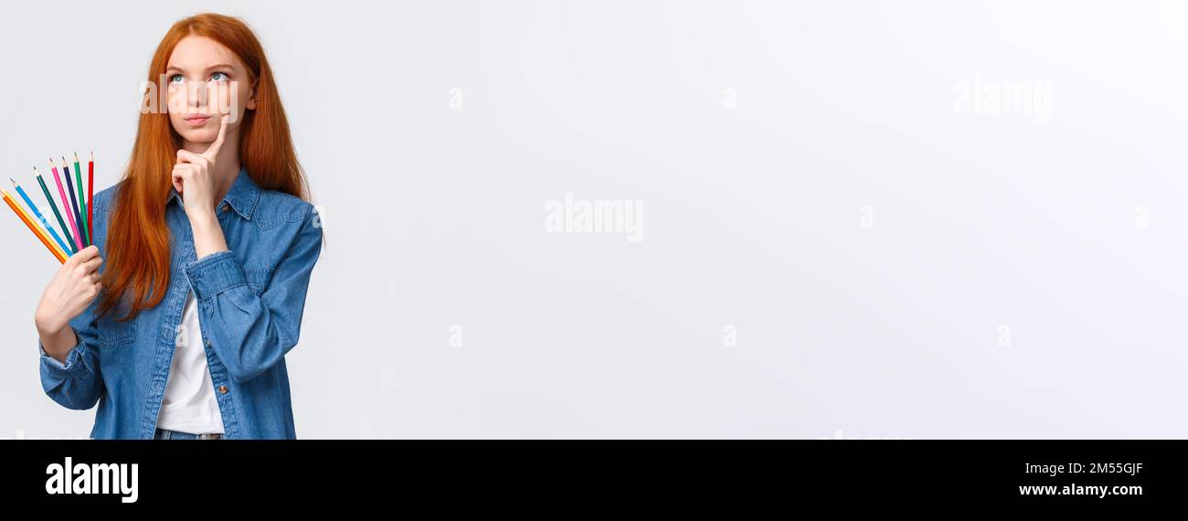 Thoughtful and focused, serious-looking determined redhead female ...