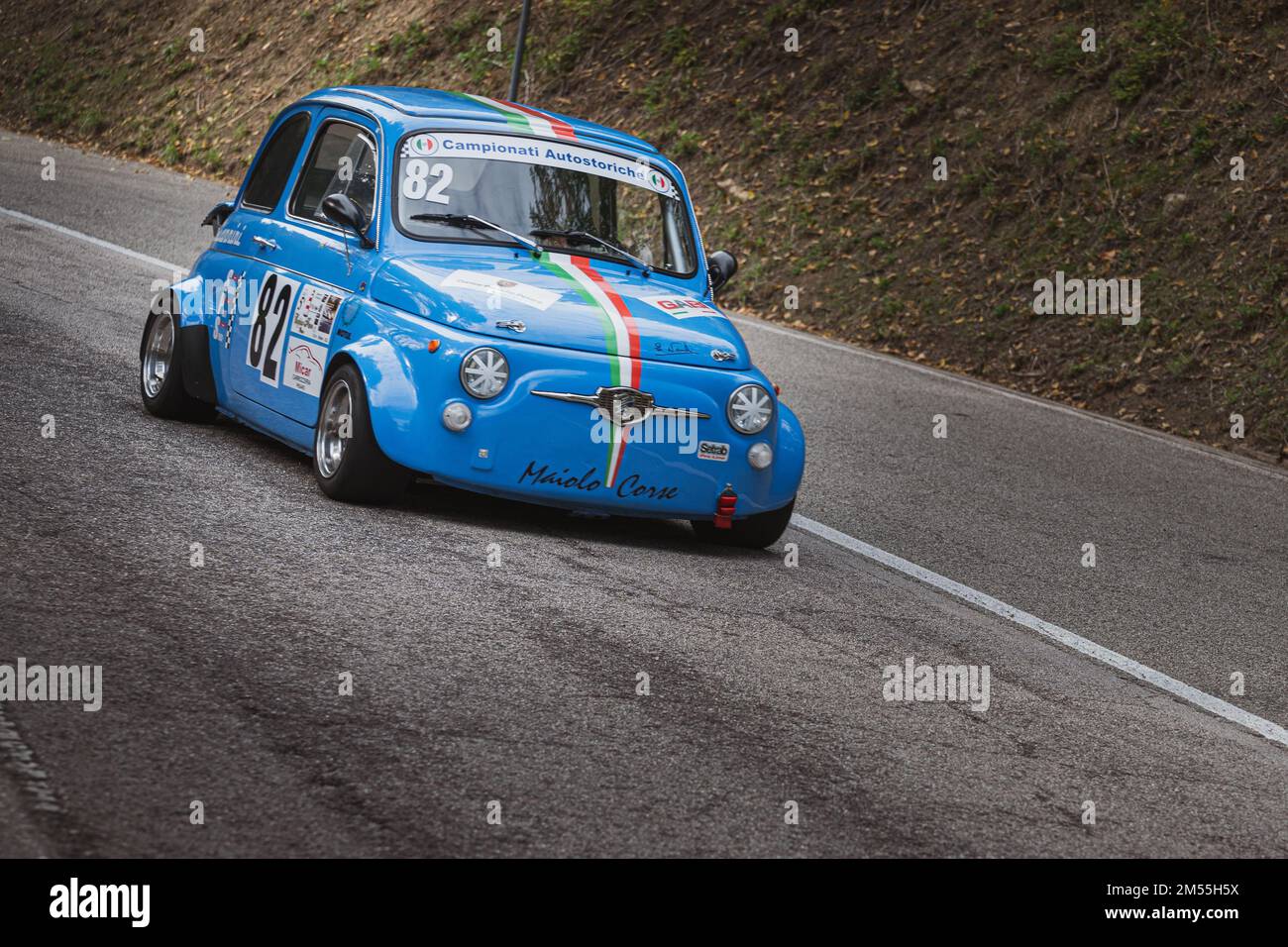 A blue Fiat 500 abarth retro racing car on the road in San Bartolo park ...