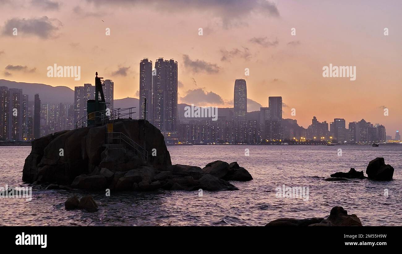 The Lei Yue Mun Coast lighthouse surrounded by skyscrapers in Hong Kong ...