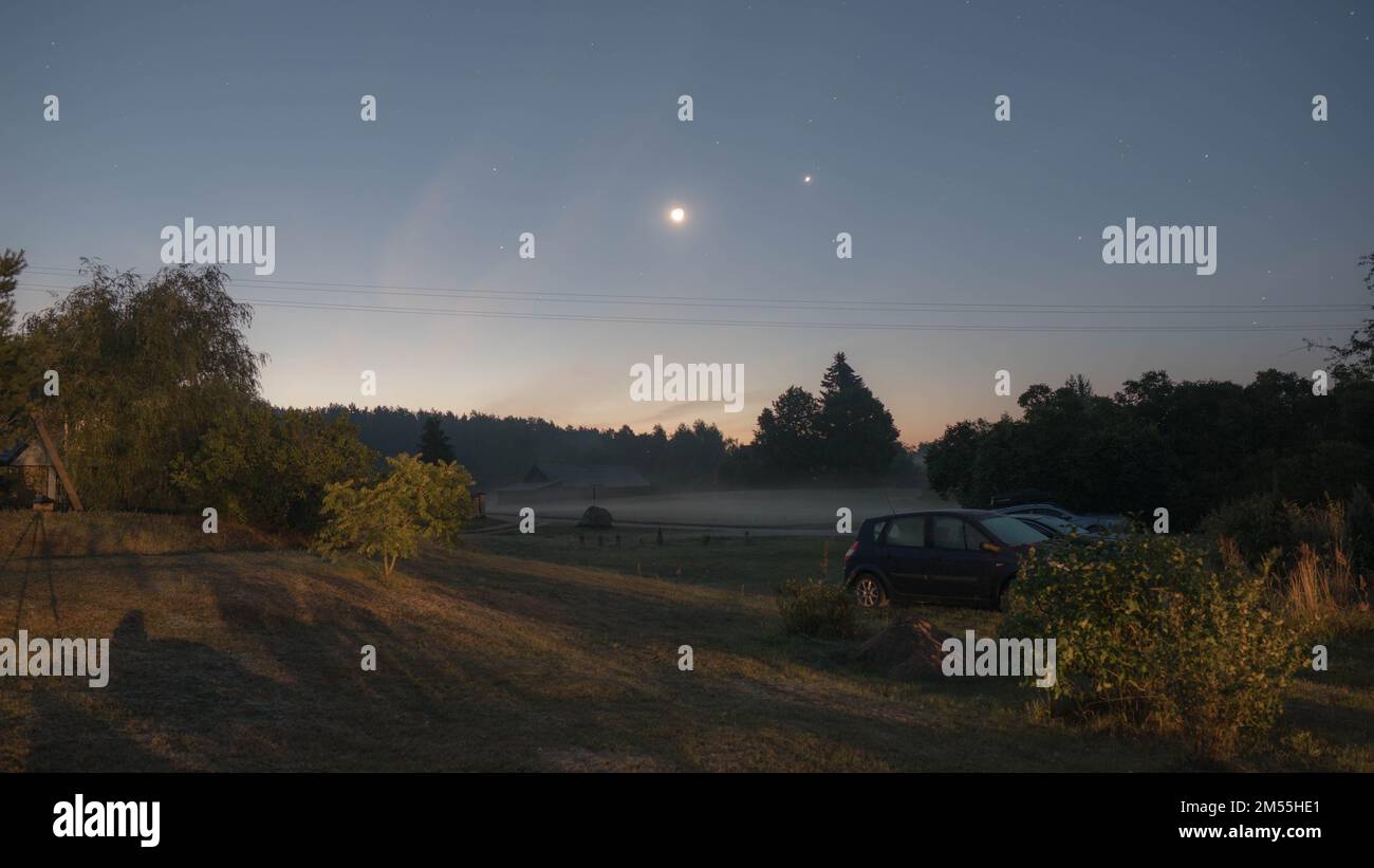 A lovely view of the countryside in Rudesa, Lithuania with the moon ...