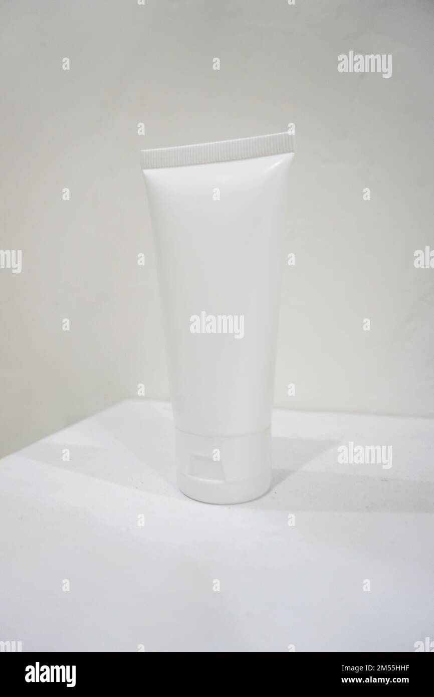White Plastic Tube on White Table Mockup Scene Stock Photo - Alamy