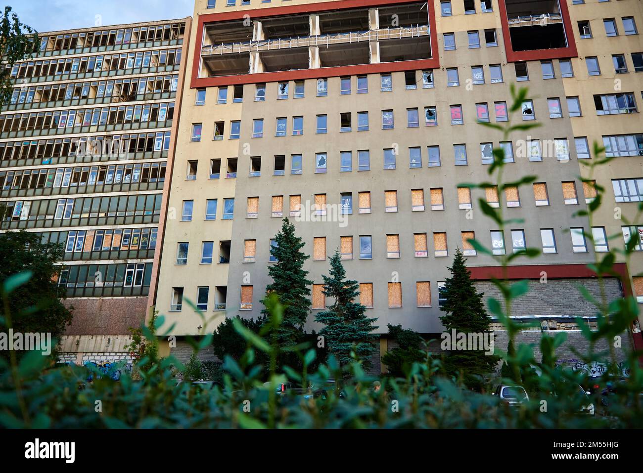Facade of abandoned residential building with broken windows. Damaged ...
