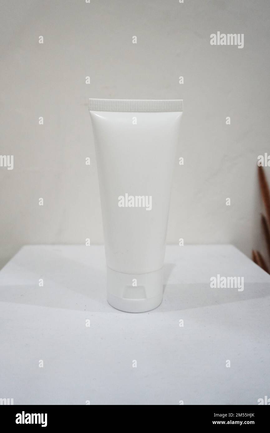 White Plastic Tube on White Table Mockup Scene Stock Photo - Alamy