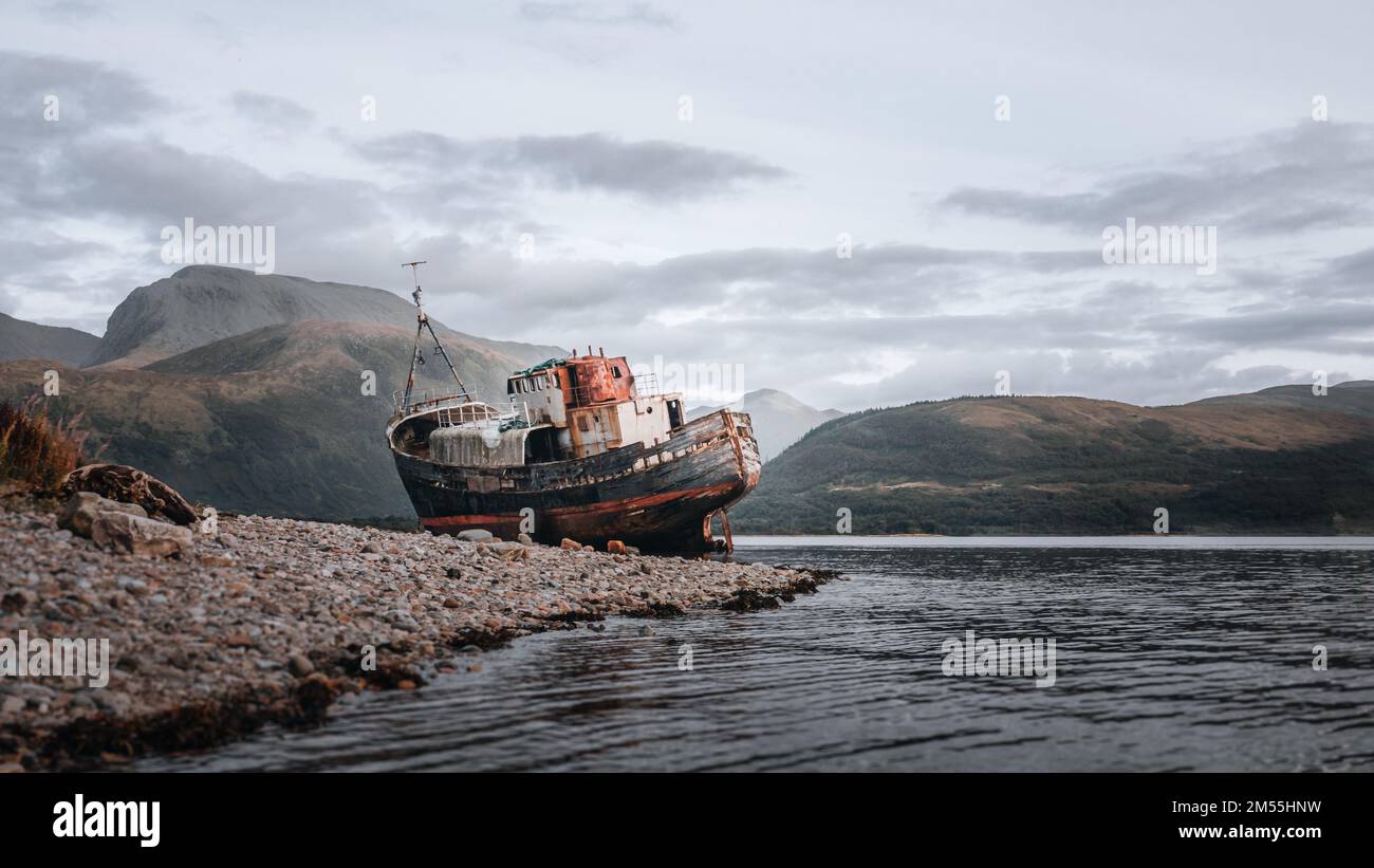 An old abandoned ship on the coast in Fort William town in Scotland ...