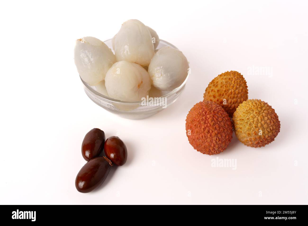 whole fresh lychees, peeled and with their bones on a white background ...