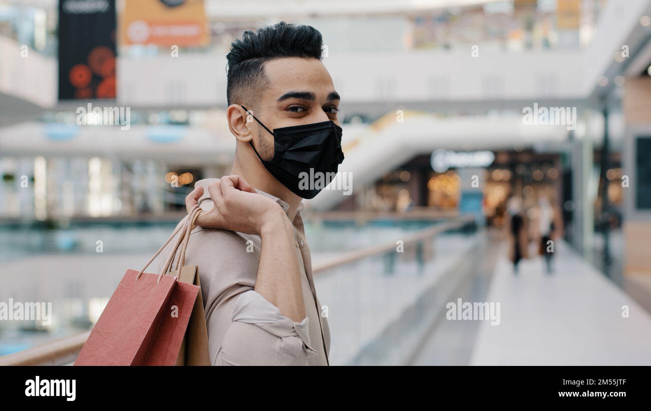 Masked stylish ethnic guy Indian Hispanic man in face medical mask ...