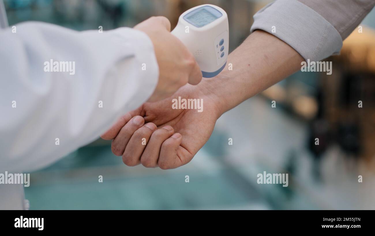 Unknown medical worker check body temperature fever scan screen hand of ...