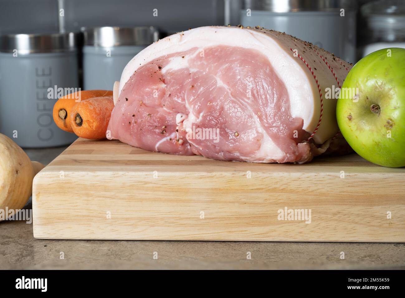 Butchered Pork leg shoulder joint with cooking apple parsnip and ...