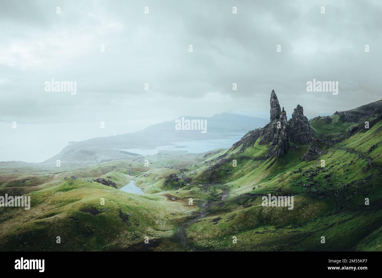 A scenic view of green slopes of The Storr on a cloudy day in the ...