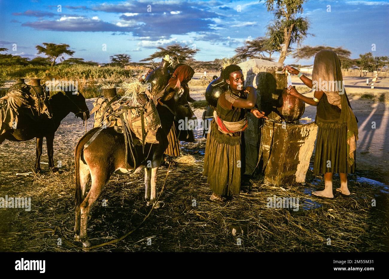 Women collecting water at communal waterpoint hi-res stock photography ...