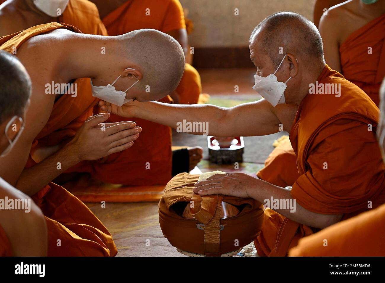 A close up view of a monk performing a blessing as 22year old ½ Thai ½ ...