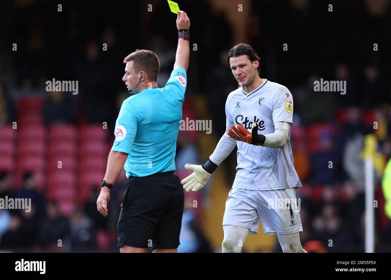 Referee Josh Smith shows a yellow card to Watford goalkeeper Daniel ...