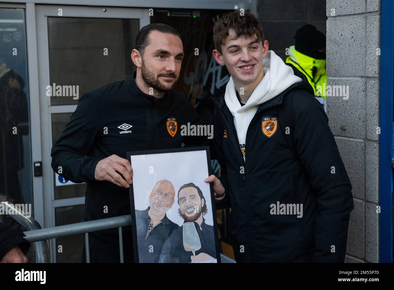 Lewis Coyle #2 of Hull City receives a hand drawn portrait from a hull ...