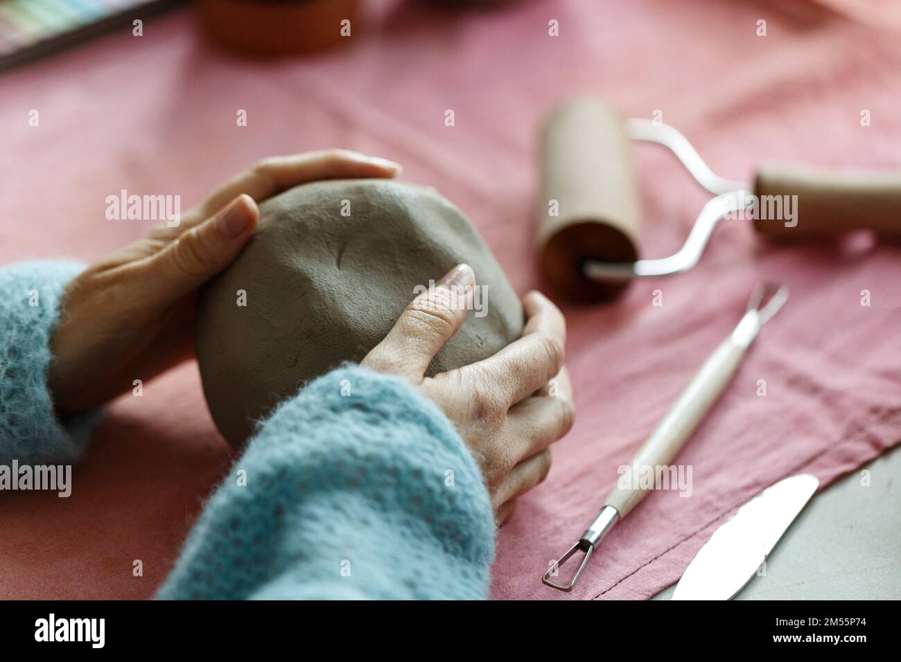 Female pottery artist preparing clay for molding. Close Up view of ...