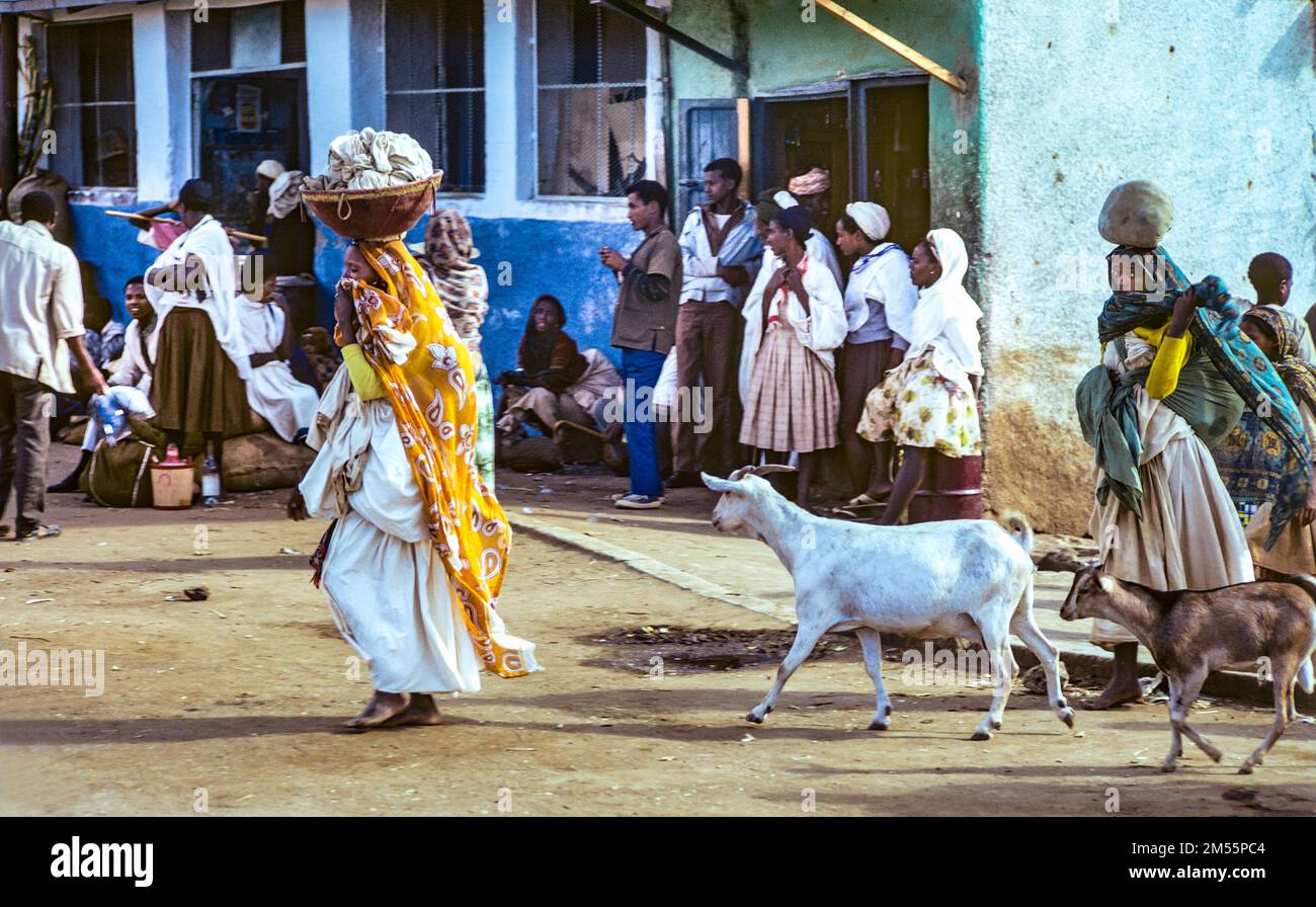 Ethiopia, 1970s, Harar, crowded market, woman carrying a basket on her ...