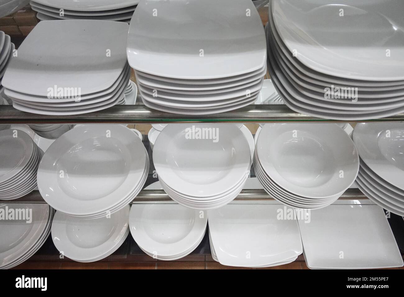 Stacked plates in a shop or restaurant Stock Photo - Alamy