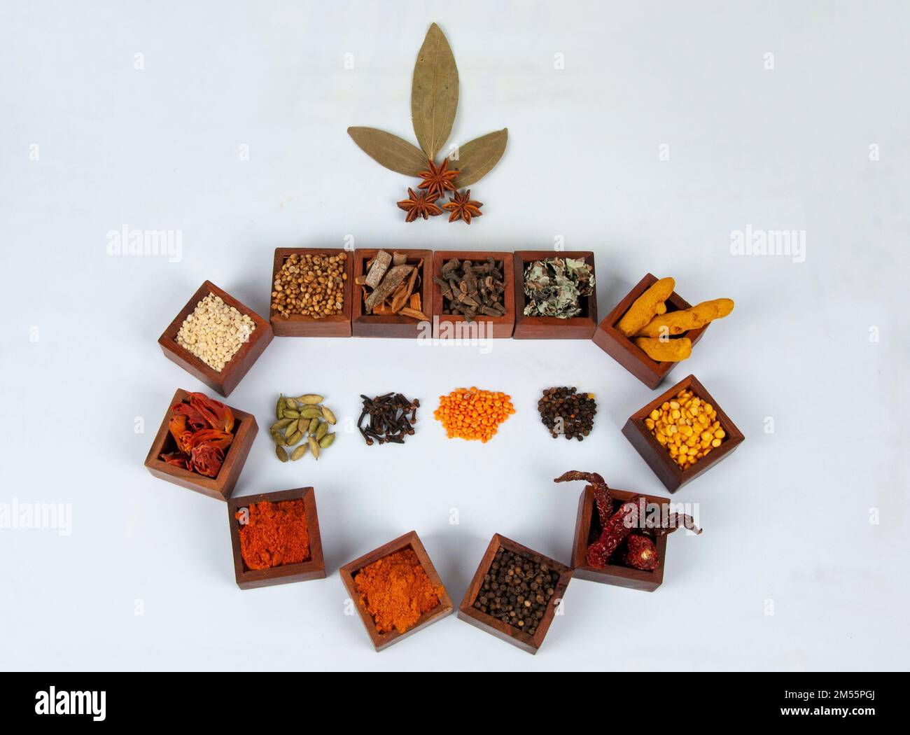 A top view of flavorful and spicy Indian spices served in wooden boxes ...