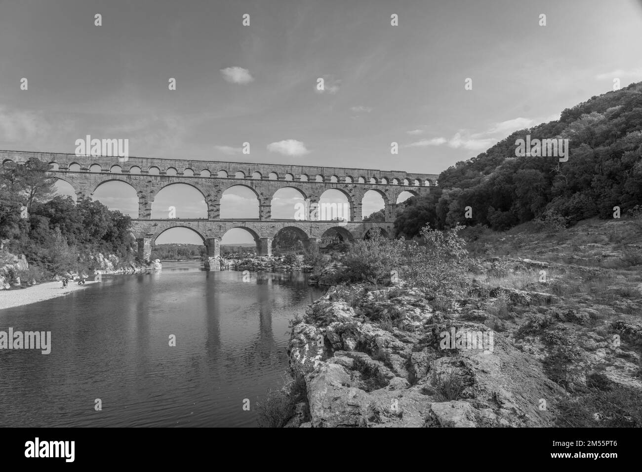 Pont du Gard three-tiered aqueduct on the river Gardon in Black white ...