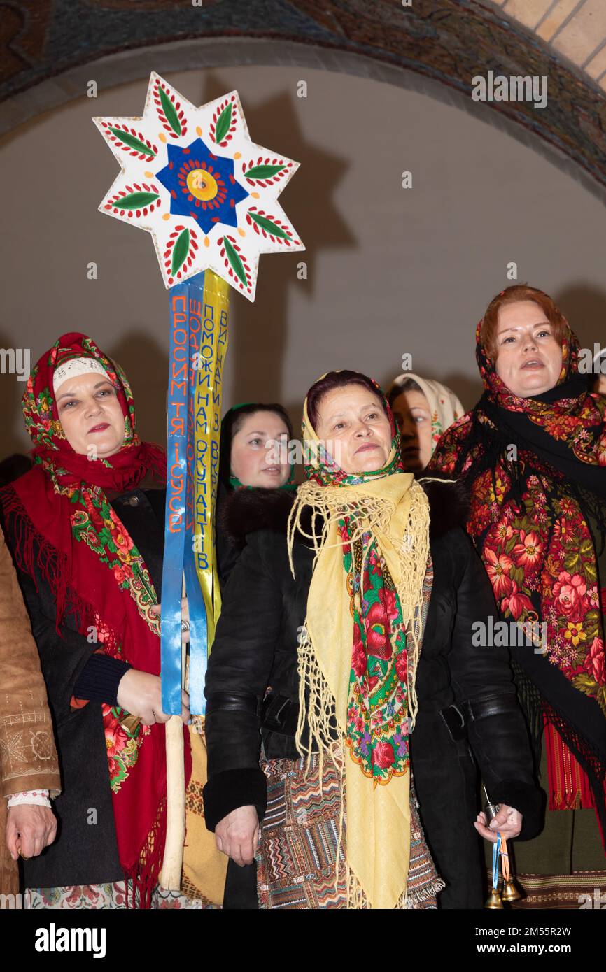 Ukrainians in folklore costumes sing carols, and hold a Christmas star ...