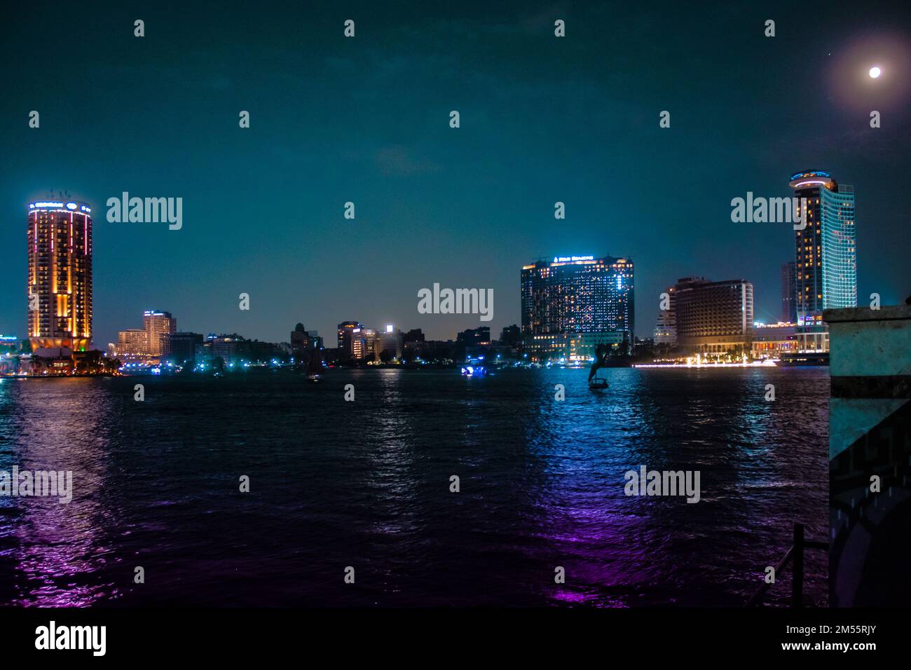 river Nile in Egypt night lights, neon lights reflected on Nile water ...