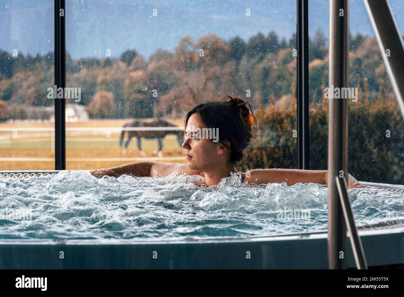 A closeup shot of a female taking a therapy bath in a jacuzzi and ...