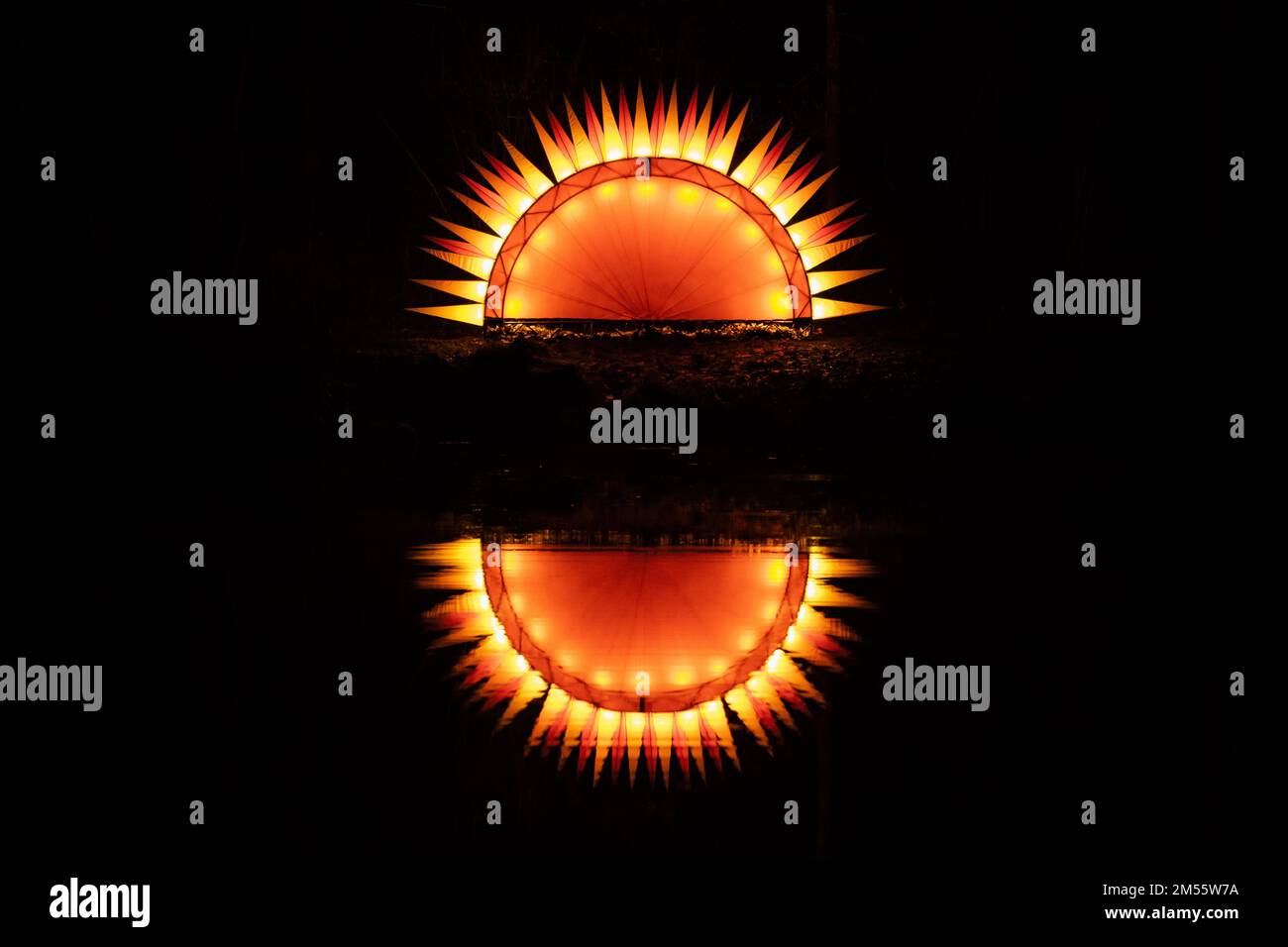 Artificial fantastic sun with sun rays or flames rising or setting ...