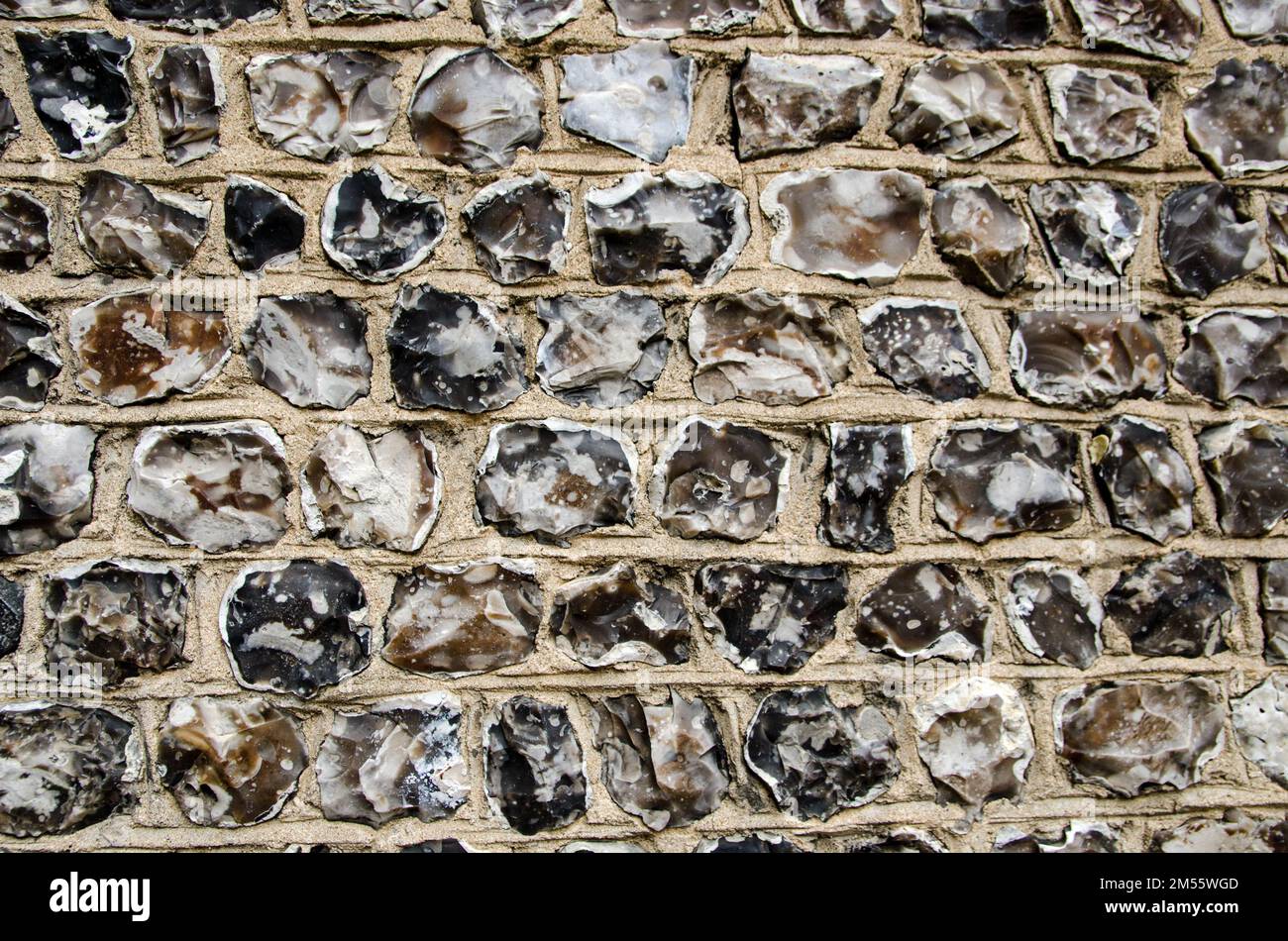 Close up view of napped flint stones forming a wall in historic ...