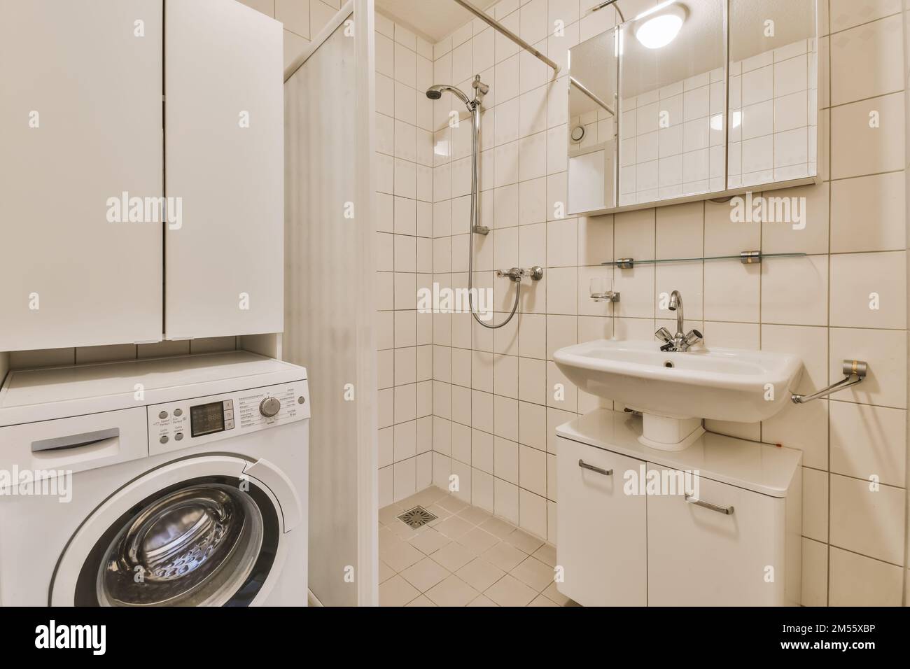 a laundry room with a washer and dryer on the wall, in front of a ...