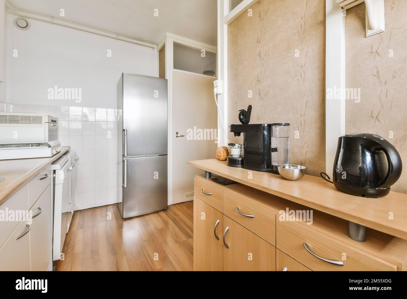 a kitchen with wood flooring and white appliances on the counter top in ...