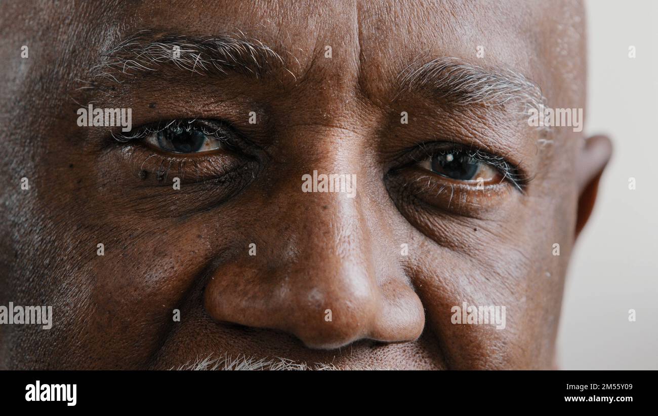 Macro extreme close up half part of face elderly middle-aged African ...