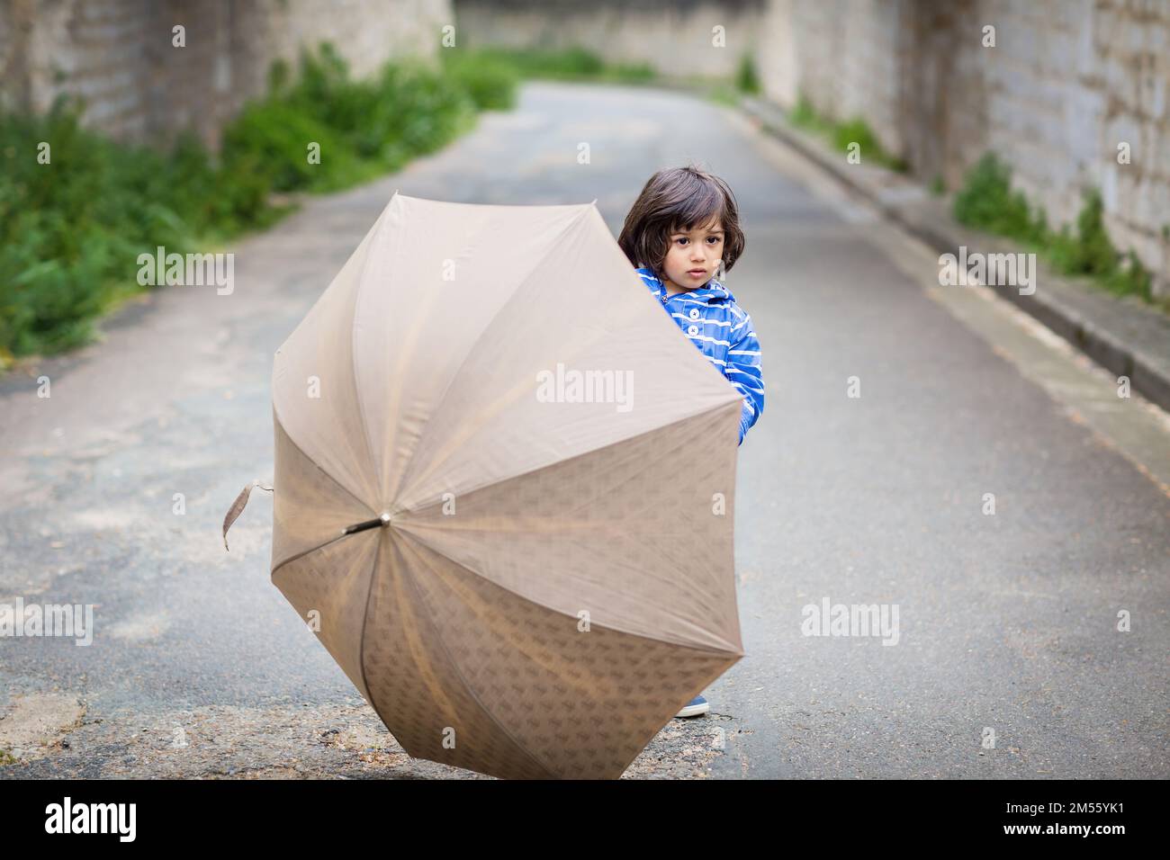Little handsome baby boy playing with umbrella outdoor Stock Photo - Alamy