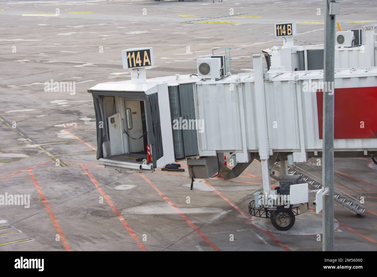 Teletrap at the airport terminal and a standing plane in the distance ...
