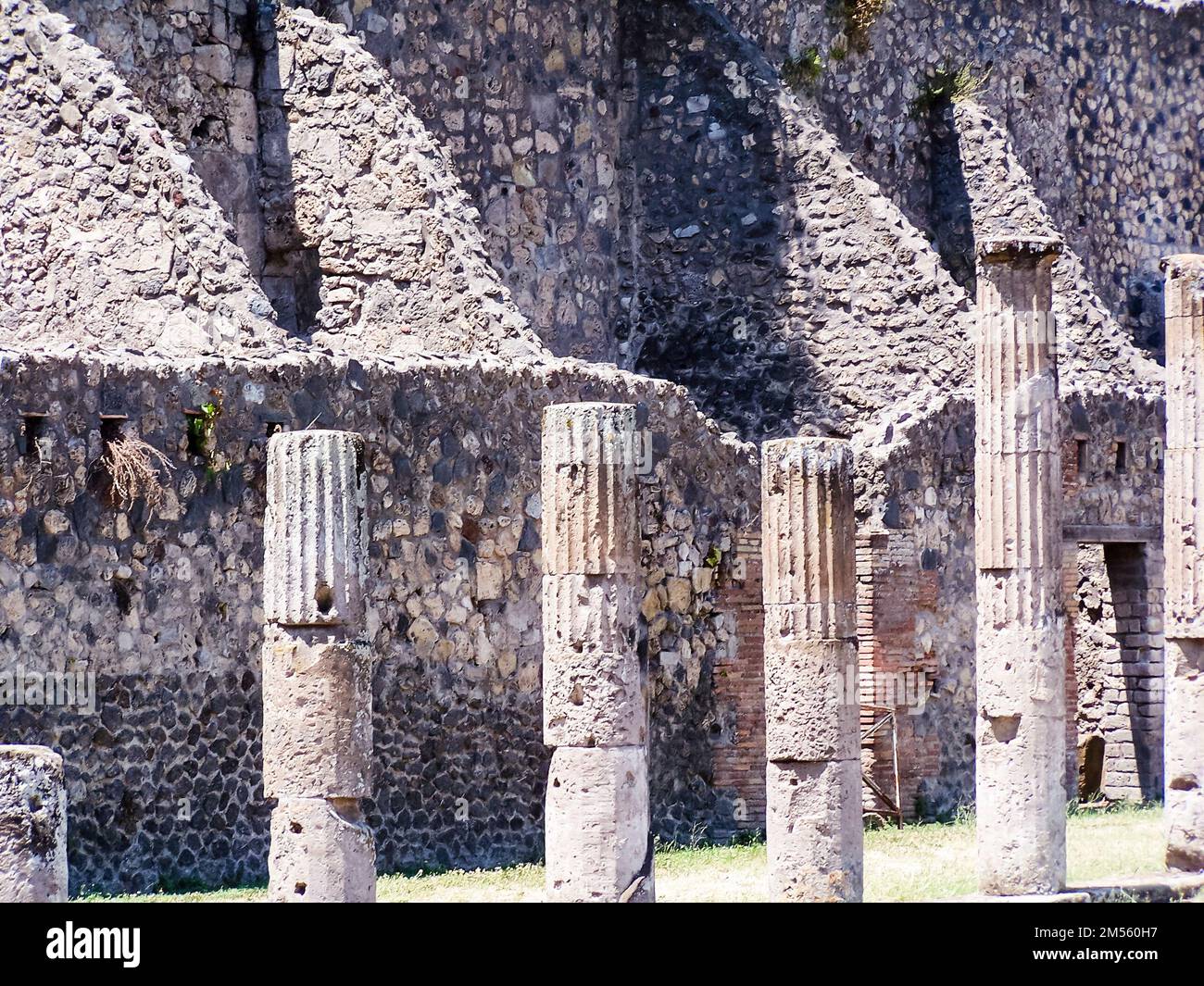 Carved pillars inside the amphitheatre at Pompeii, Italy Stock Photo ...
