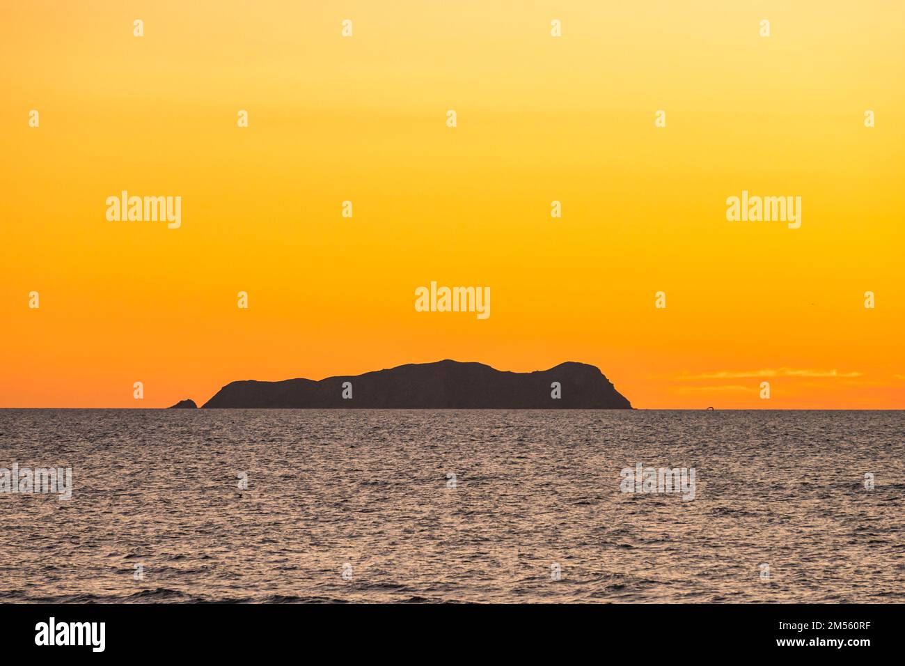 Scenic view of island during sunset Stock Photo - Alamy