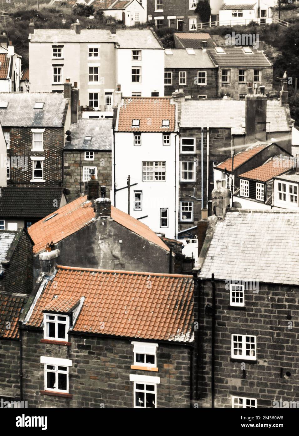 The vertical shot of colorful rooftops of the fishing port of Staithes ...