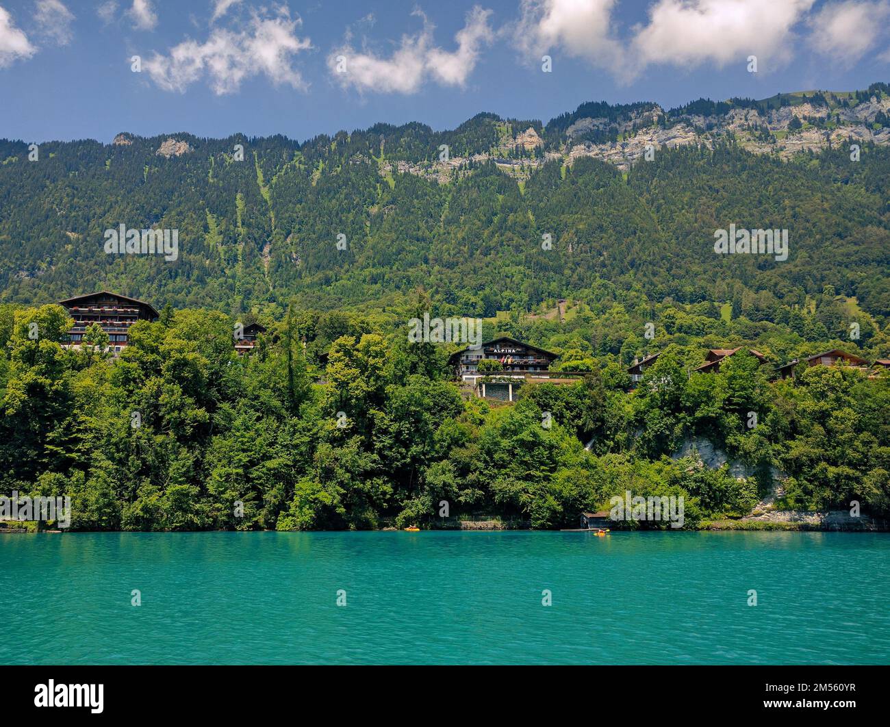 A beautiful shot of buildings in forested mountains by a lake Stock ...
