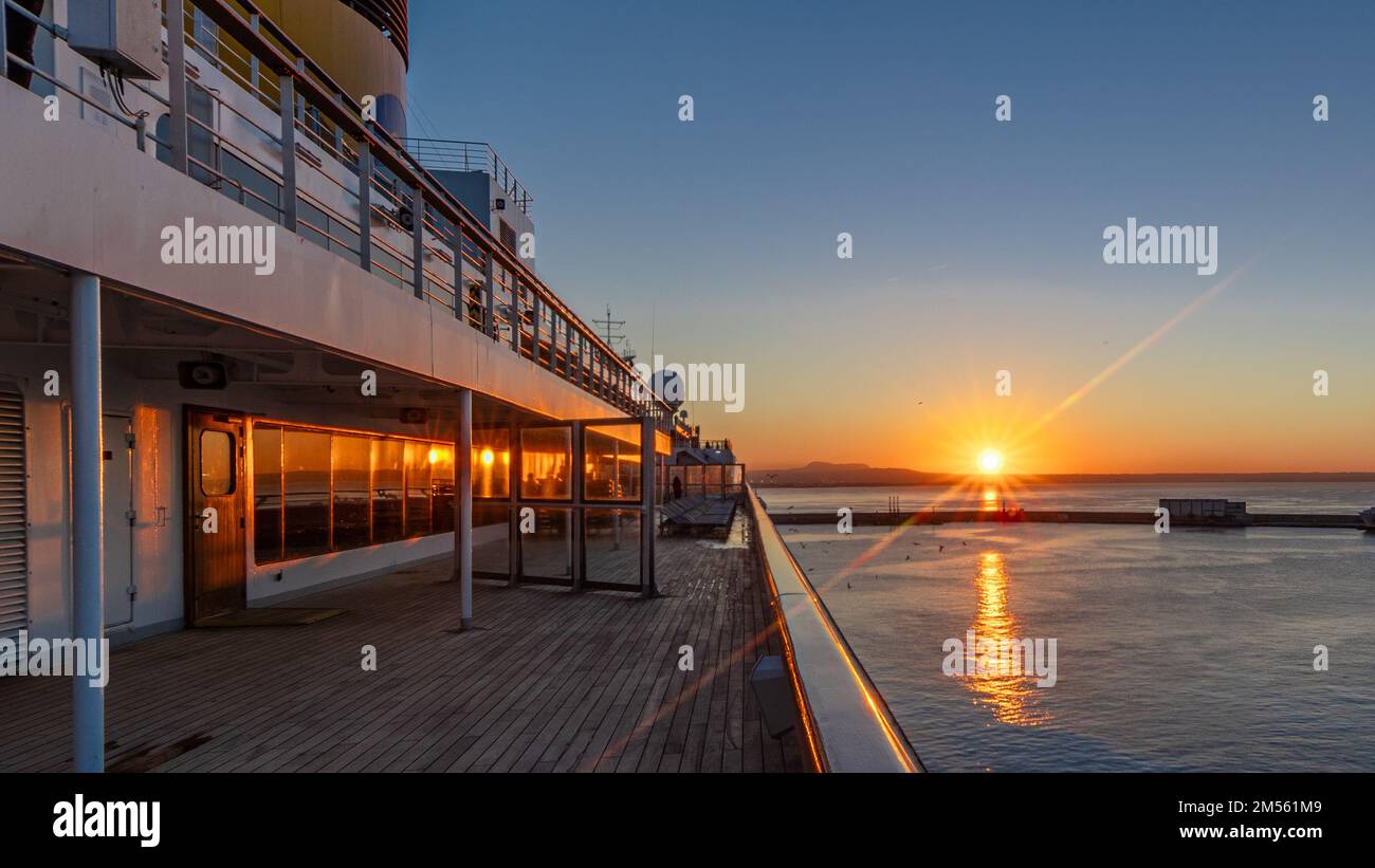 Promenade deck of a cruise ship in navigation with sunset Stock Photo ...