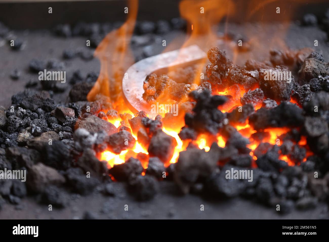 Smithy forging for hardening and heating iron. Blacksmith working at ...