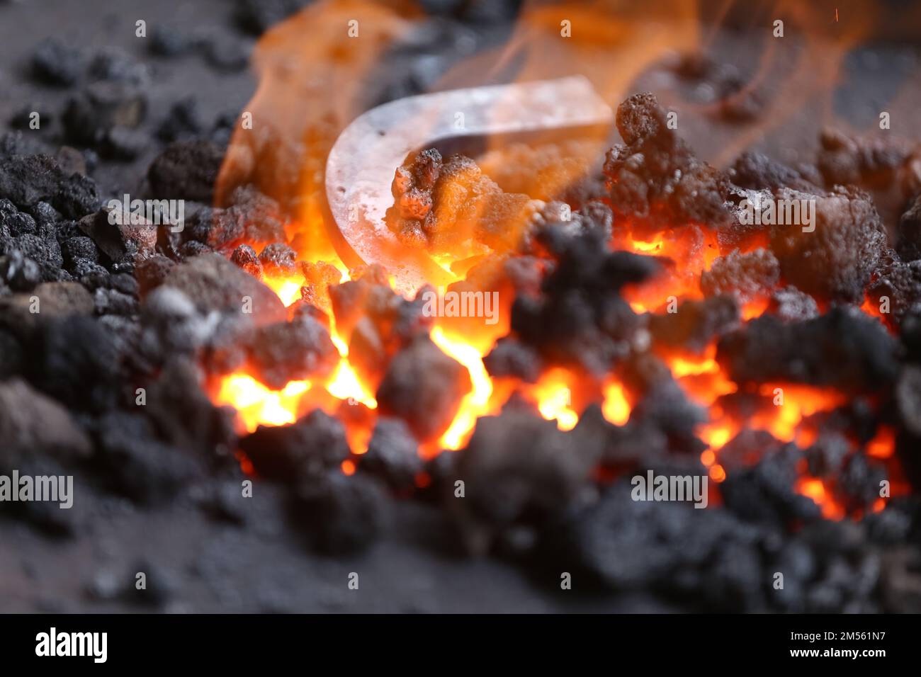 Smithy forging for hardening and heating iron. Blacksmith working at ...