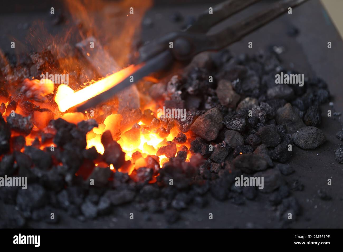 Smithy forging for hardening and heating iron. Blacksmith working at ...
