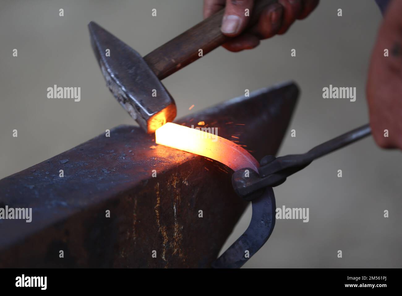 Smithy forging for hardening and heating iron. Blacksmith working at ...