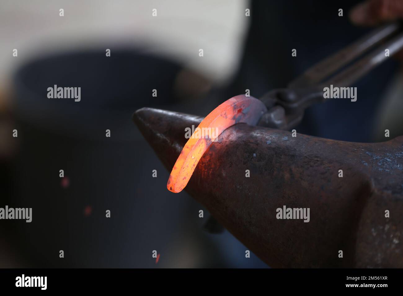 Smithy forging for hardening and heating iron. Blacksmith working at ...