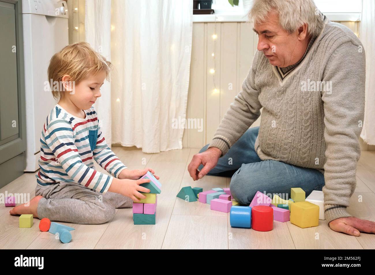 Old Grandfather and Little Boy Playing with Wooden Blocks on the Floor ...