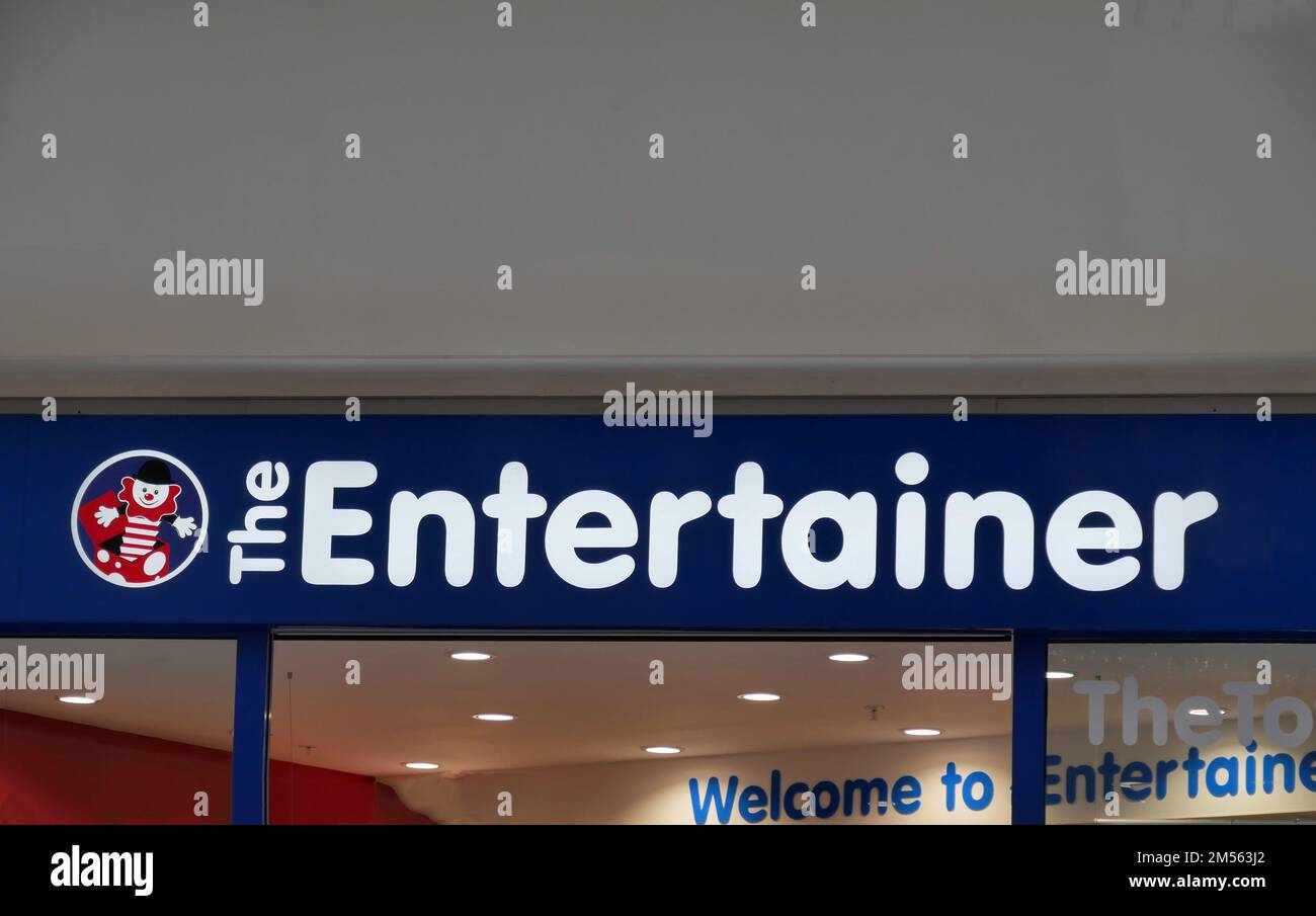 Blue shop sign with white letters over entrance boors Stock Photo - Alamy